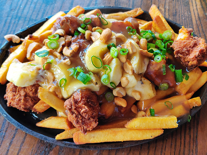Breakfast poutine that would make Canadians jealous &ndash; golden fries, savory gravy, melty cheese curds, and what appears to be fried chicken. Morning glory!