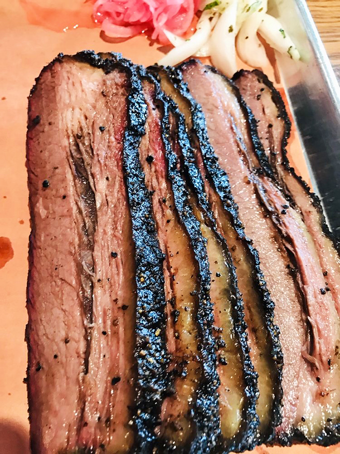 Brisket so perfect it makes grown adults weep. That bark, that smoke ring, that melt-in-your-mouth tenderness—this is meat nirvana.