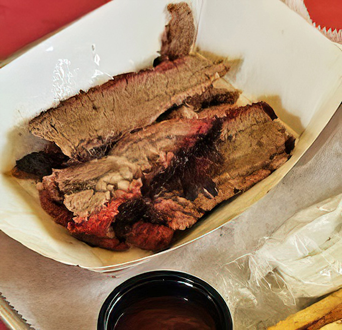 Behold the holy grail of smoked meats&mdash;brisket with that telltale pink smoke ring that whispers, "I've been loved for hours." No Instagram filter needed.