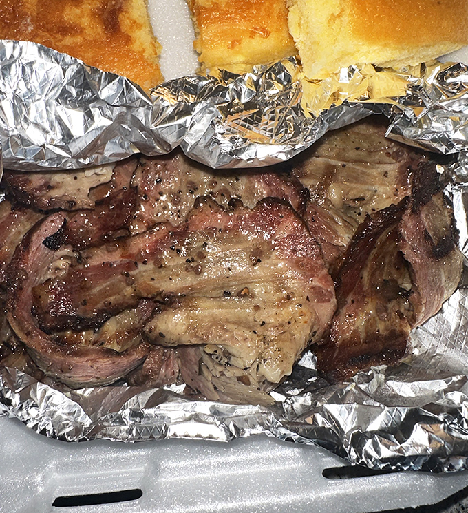 Behold the brisket in all its glory – the bark so perfect it could make a Texas pitmaster weep with joy.