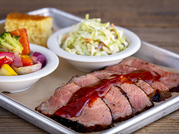 Brisket so perfectly sliced it belongs in a museum of meat artistry. That smoke ring isn't just pink&mdash;it's a halo of flavor.