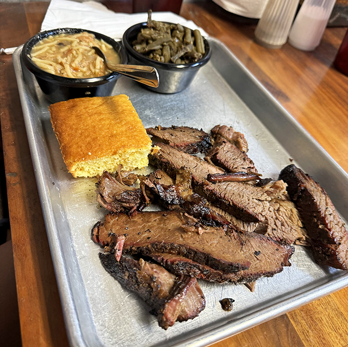 Brisket so tender it practically surrenders to your fork, served with mac and cheese that could make a grown man weep.