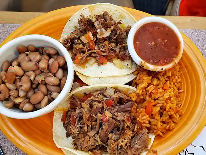 Behold the star of our show: brisket tacos that make you question every life decision that didn't involve eating them sooner. Served with beans and rice that refuse to be mere sidekicks.