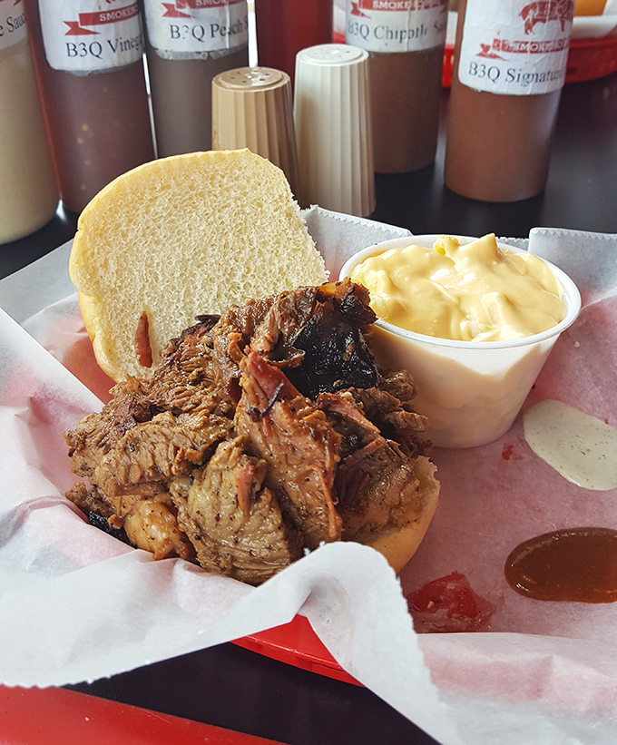 Behold the star of the show—tender brisket with that coveted smoke ring, nestled in a bun that somehow manages to contain all that smoky glory.