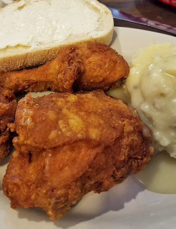 The broasted chicken arrives with a golden crust that makes a satisfying crack when your fork hits it - nature's perfect sound effect for impending deliciousness.