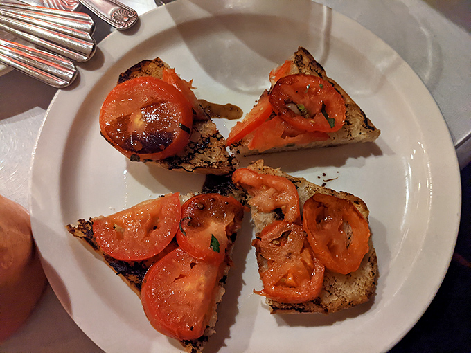 Bruschetta that deserves its own fan club – perfectly toasted bread topped with tomatoes so vibrant they practically sing opera.