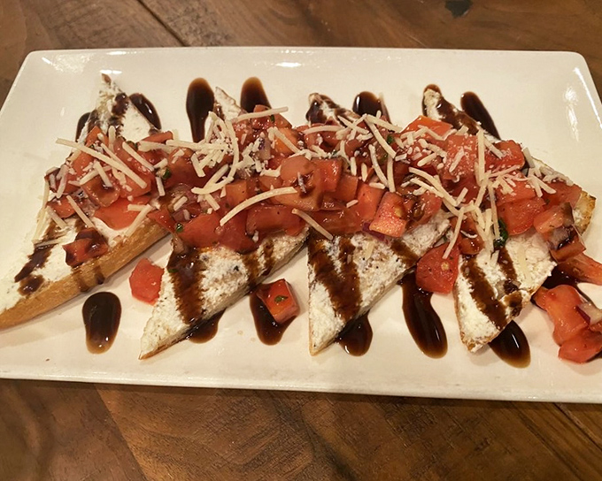 This bruschetta isn't just appetizer &ndash; it's edible art. Crisp bread, creamy cheese, fresh tomatoes, and that balsamic drizzle you'd happily drink straight.