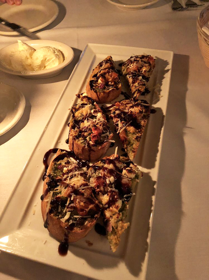 These bruschetta bites aren't just appetizers; they're little flavor bombs topped with enough cheese to make Wisconsin nervous.