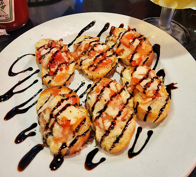 Bruschetta that would make your Italian grandmother weep with joy. The balsamic drizzle adds that perfect sweet-tangy finish to tomatoes so fresh they're practically still sunbathing.