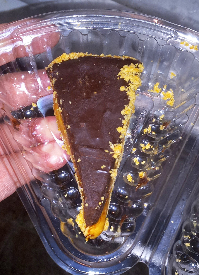 The legendary Buckeye Pie in its natural habitat—a to-go container that won't make it home. That chocolate-topped peanut butter filling is Ohio's greatest contribution to American desserts.