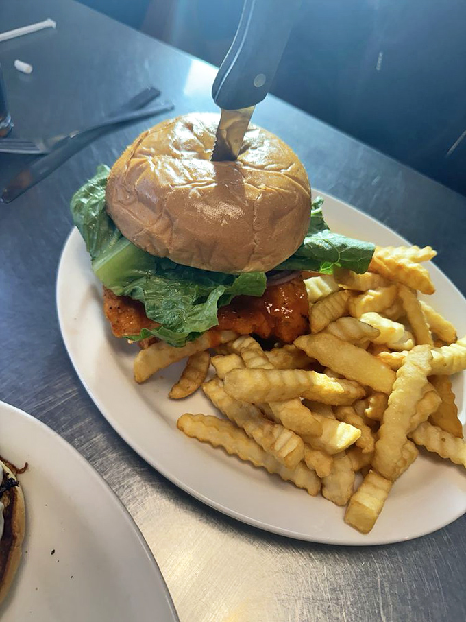 This isn't just a sandwich; it's architecture with flavor. The crispy chicken and golden fries are a masterclass in comfort.