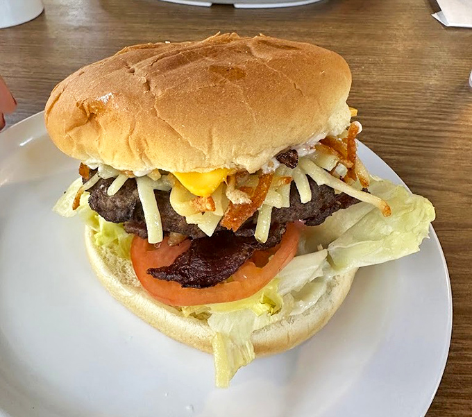 This isn't just a burger; it's edible architecture. Layers of beef, bacon, cheese, and fresh toppings create a masterpiece that requires both hands and zero regrets.