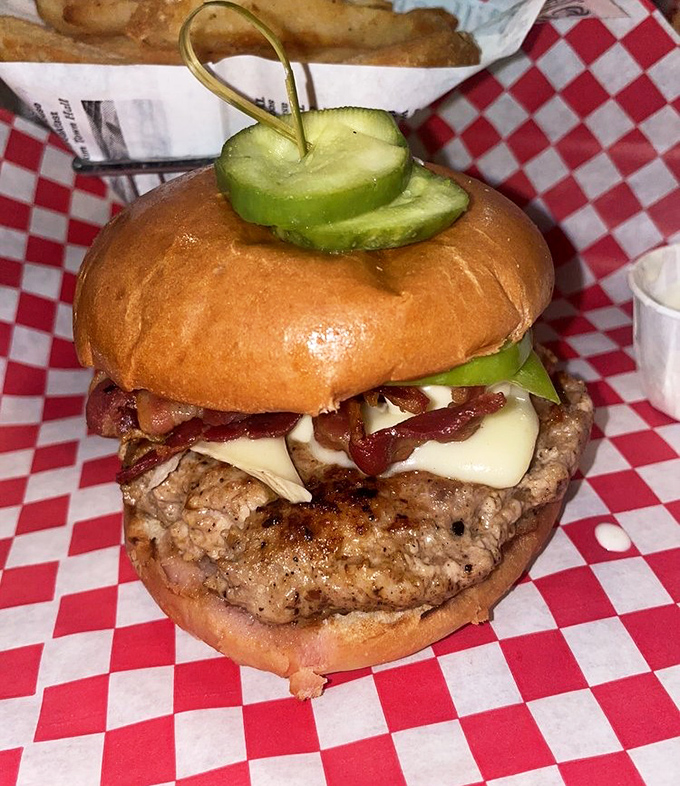 This isn't just a burger &ndash; it's architecture. Note the strategic pickle placement and the perfect cheese-to-bacon ratio.