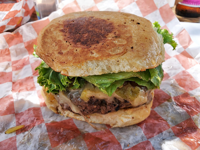 This isn't just a burger&mdash;it's edible architecture, a perfectly balanced tower of beef, cheese, and fresh veggies that demands both hands and your full attention.