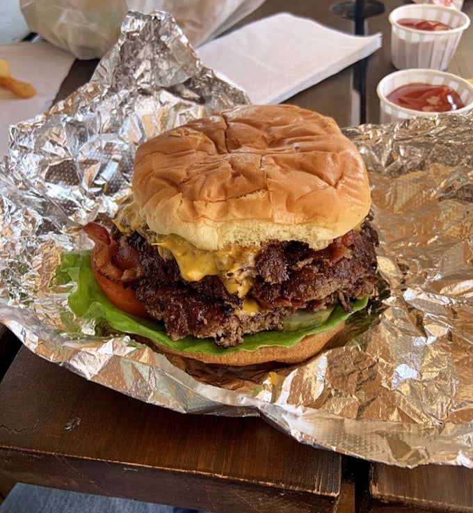 This isn't just a burger; it's a masterpiece of beef architecture. The melted cheese cascading down those patties is performing what can only be described as a flavor avalanche.
