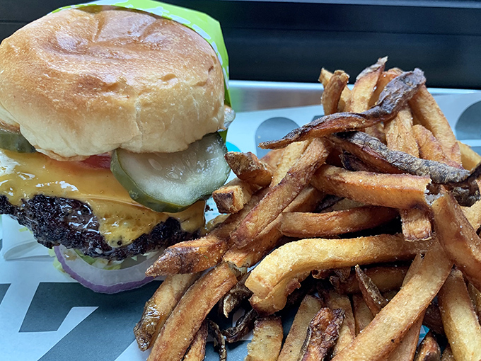 This isn't just a burger and fries &ndash; it's edible architecture. The golden ratio of beef to cheese to pickle, with fries that deserve their own fan club.