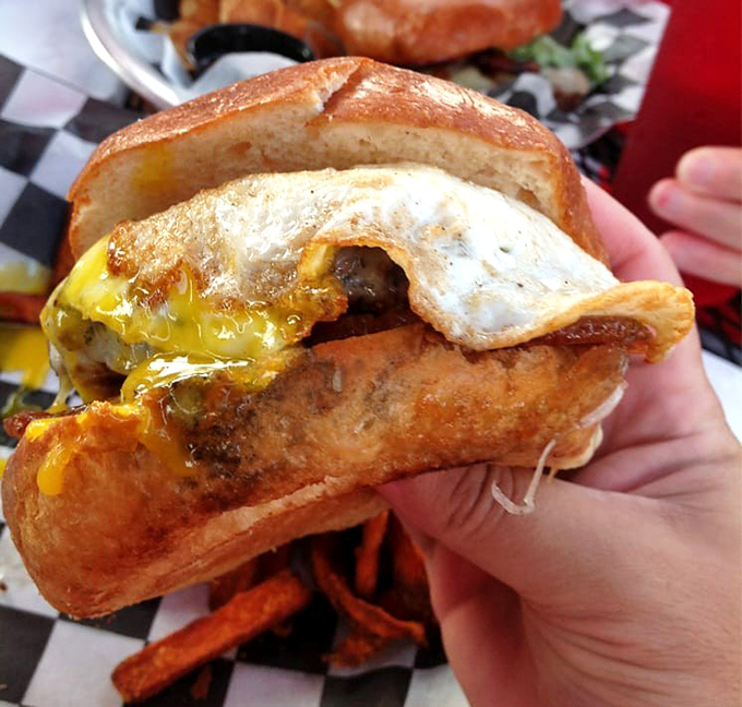 Behold the breakfast burger in all its glory – where a perfectly fried egg crowns the beef like a royal hat at Ascot, but infinitely more delicious.