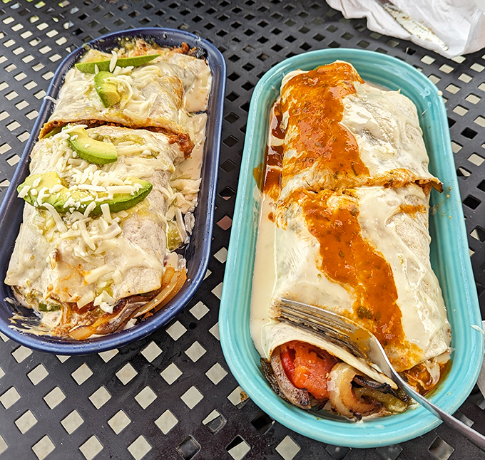 Behold: the burrito duo that launches road trips. One adorned with avocado slices, the other bathed in a sunset-colored sauce&mdash;both magnificent.