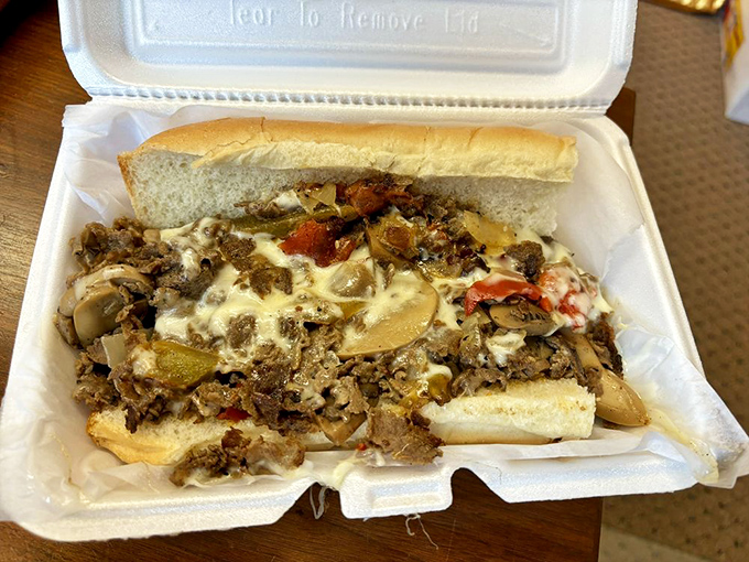 Behold the Philly-area miracle: a proper cheesesteak loaded with savory meat, peppers, and onions under a blanket of molten cheese. It's the sandwich equivalent of a warm hug.