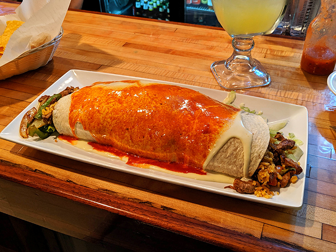 This isn't just a burrito&mdash;it's an architectural marvel wrapped in a tortilla, with sauce cascading down its sides like delicious lava from a flavor volcano.