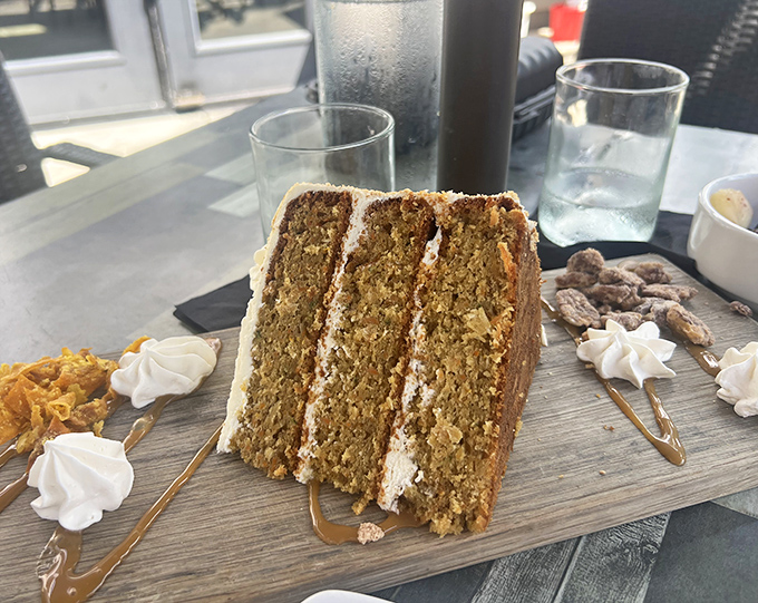 The legendary carrot cake in all its three-layer glory. Like finding the Holy Grail of desserts—if Indiana Jones were hunting for the perfect balance of spice, moisture, and cream cheese frosting.