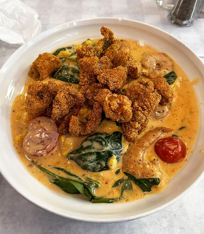Cornmeal-crusted catfish crowns a creamy sea of shrimp-studded grits. This isn't breakfast; it's an edible Southern sonnet.