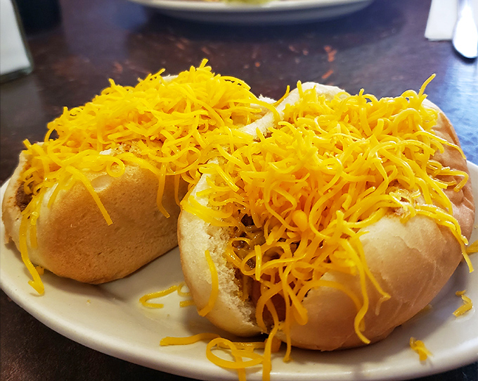 Behold the star attraction &ndash; a perfect cheese coney crowned with a mountain of finely shredded cheddar that threatens to avalanche with each delicious bite.