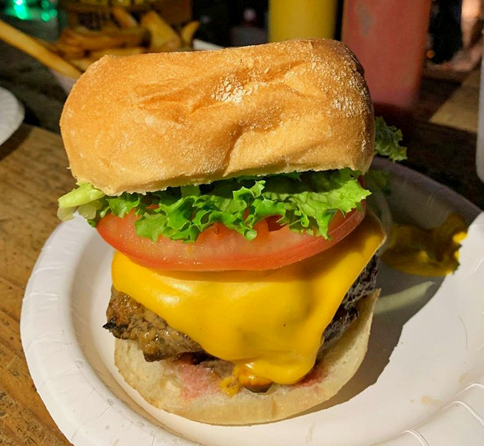 Behold the star of the show: a perfectly charred sirloin patty crowned with melted cheese, fresh veggies, and a bun that somehow contains this magnificent beast.