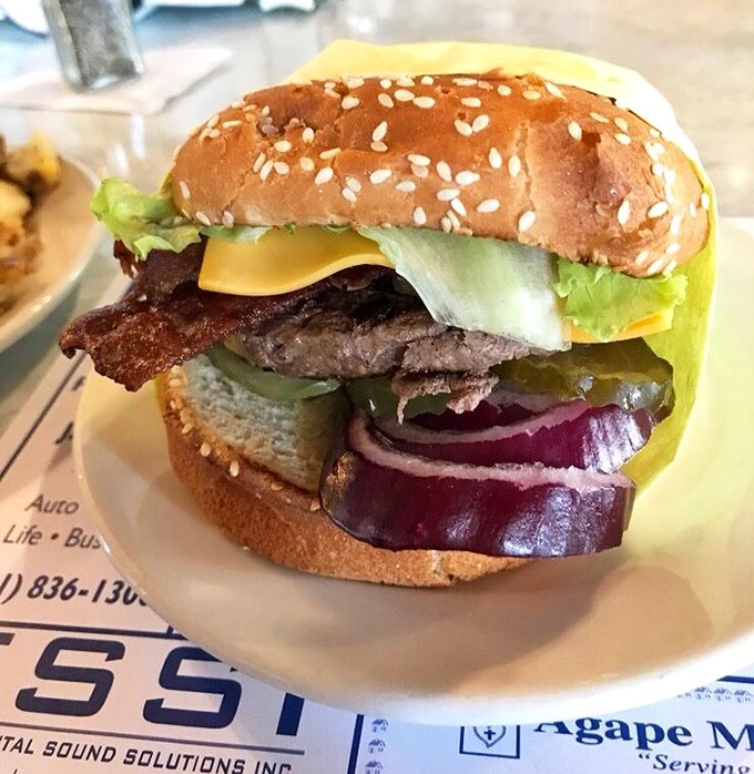 Behold the star attraction: a perfectly proportioned burger where every element plays its essential role in the symphony of flavor that awaits your first bite.