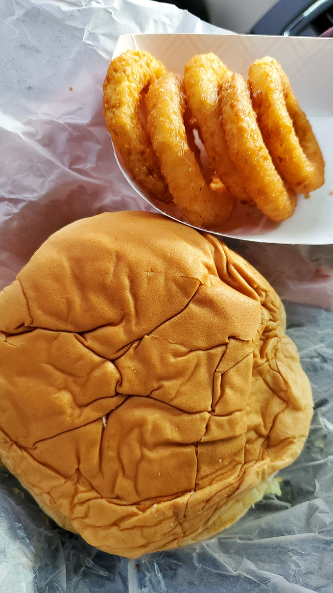 A perfectly toasted bun cradles the star attraction, accompanied by golden onion rings. Simple pleasures that make Monday feel like Saturday.