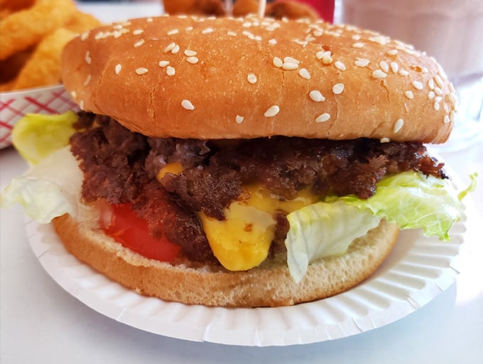 Behold the star attraction: a perfectly grilled patty crowned with melted cheese, fresh veggies, and decades of burger-making wisdom.