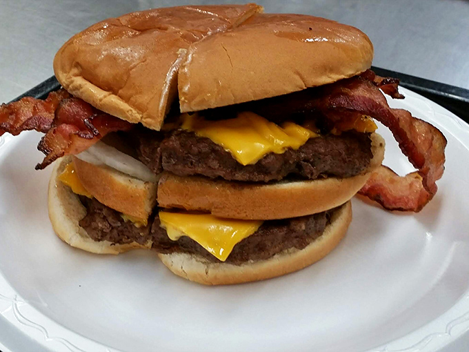 Not just a cheeseburger, but a monument to American ingenuity. Two patties, cheese, and bacon stacked like a delicious Jenga tower.