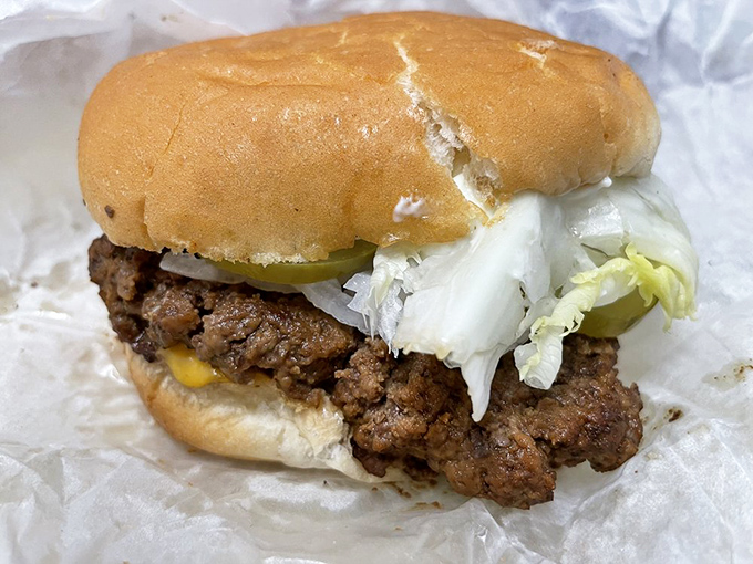 Behold the star of the show&mdash;a perfectly pressed patty with melty cheese and fresh toppings. This isn't just a burger; it's edible nostalgia wrapped in wax paper.