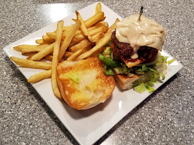 This isn't just a cheeseburger; it's edible poetry on a plate. The golden fries and perfectly toasted bun are merely supporting actors to the beefy star.