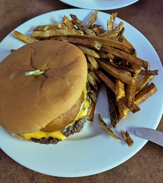 The star of the show in all its glory. This cheeseburger isn't trying to be Instagram-famous; it's too busy being delicious.