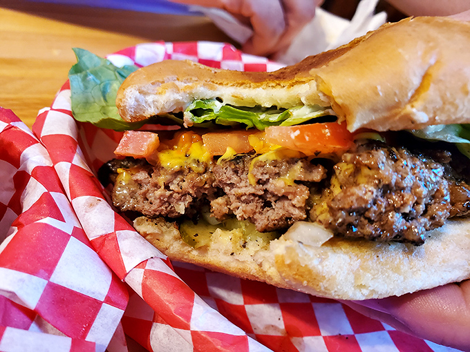 This isn't just a burger—it's edible architecture. The perfect stack of beef, cheese, and fresh veggies creates a masterpiece that requires both hands and zero shame.
