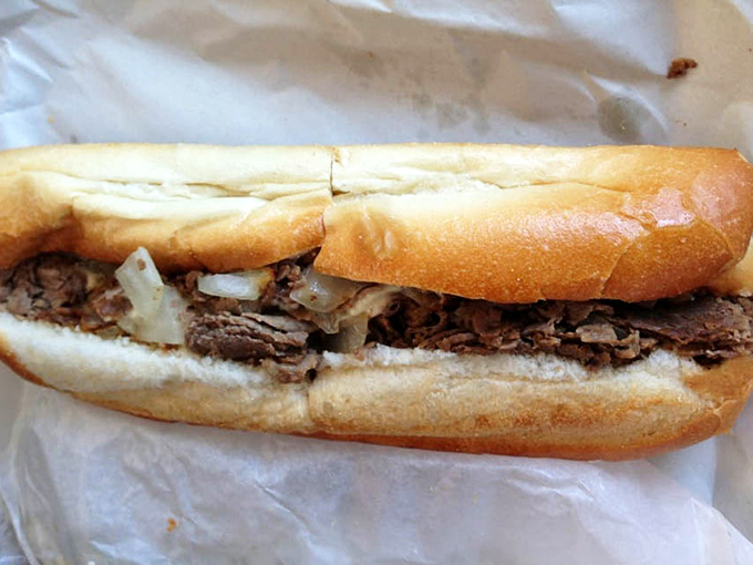 Behold the star of the show: thinly sliced ribeye nestled in a perfect roll with caramelized onions. Philadelphia, your cheesesteak crown is wobbling.