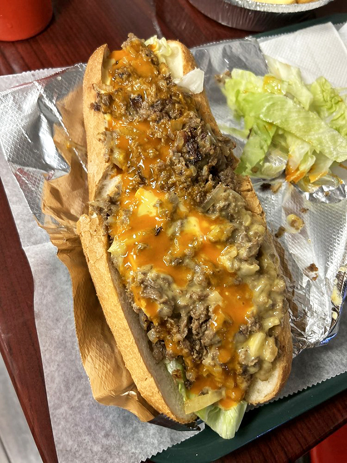 Behold the star attraction—cheese cascading over perfectly chopped steak. This isn't just a sandwich; it's edible architecture with melty golden roofing.