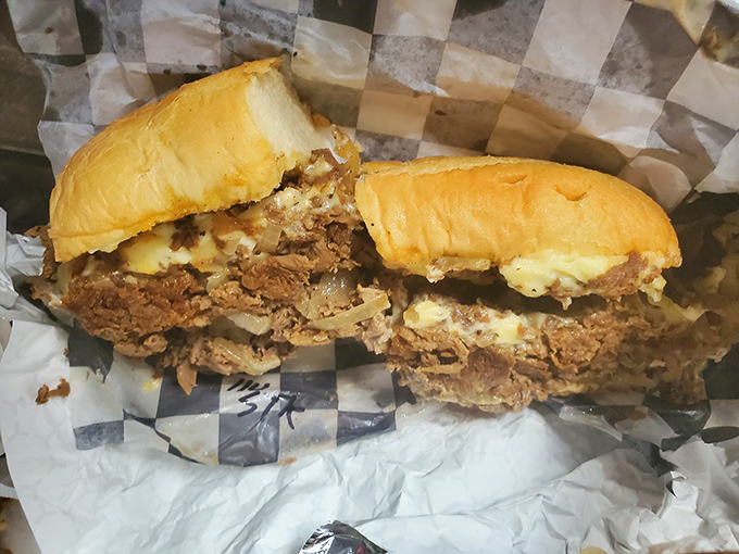 Behold the main attraction: layers of thinly sliced ribeye and melted cheese cradled in a soft roll. Poetry doesn't always rhyme; sometimes it's served in wax paper.