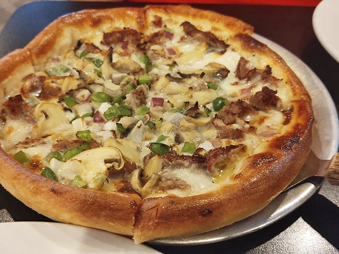 Behold the legendary Philly Cheesesteak Pizza in all its glory! Tender steak, saut&eacute;ed veggies, and cheese that stretches to infinity and beyond.