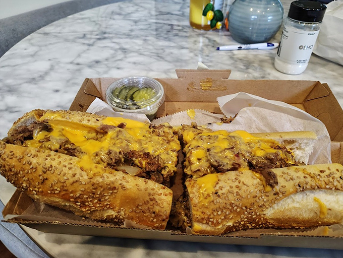 Behold the cheesesteak in its natural habitat &ndash; sesame-seeded roll, molten cheese cascading over perfectly chopped steak. Poetry in sandwich form.