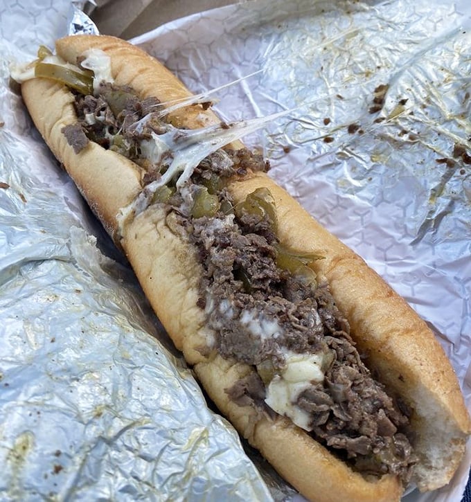 Behold the star of the show&mdash;thinly sliced beef, melted cheese, and peppers cradled in a perfect roll. This isn't just lunch; it's edible architecture.