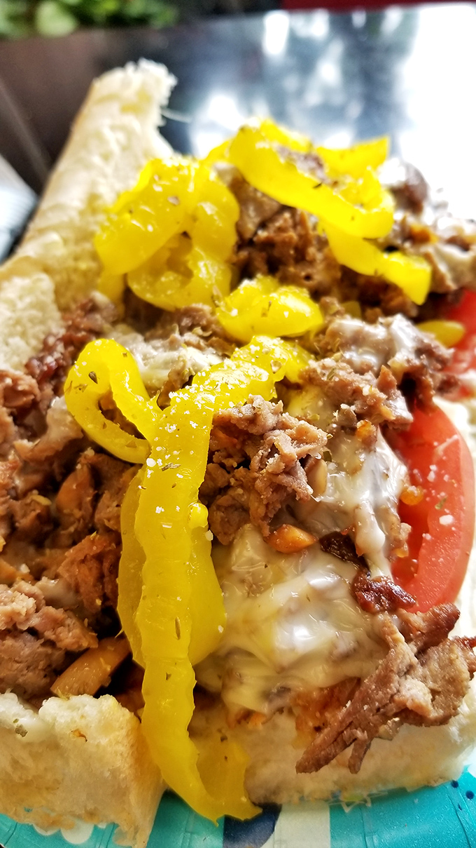Behold the star of the show! Tender ribeye, melted cheese, and those perfectly saut&eacute;ed banana peppers create a sandwich worth crossing county lines for.