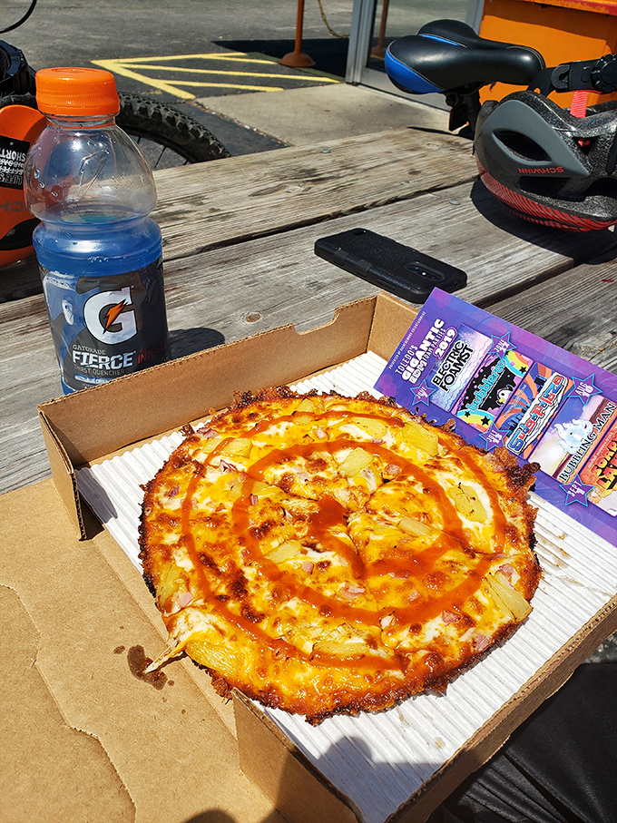 This isn't your nonna's pizza. Swirls of orange sauce dance across a perfectly crisp crust, proving that sometimes culinary rebellion tastes better than tradition.