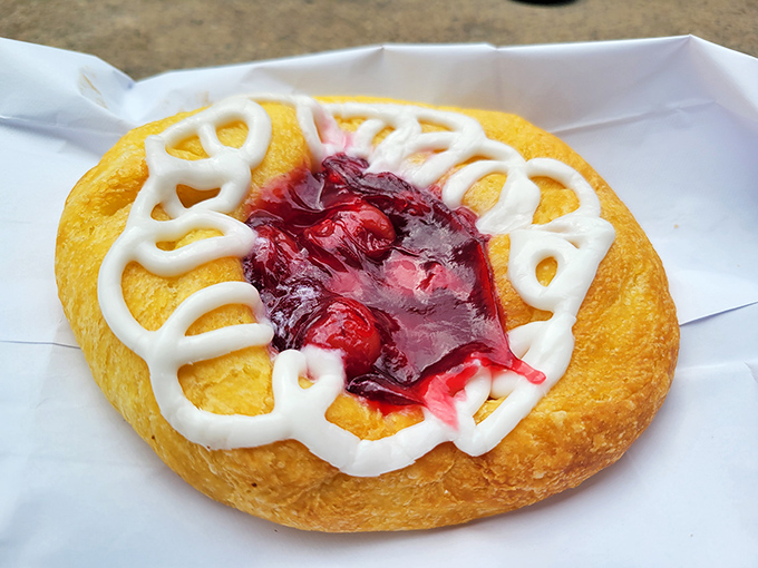 This cherry danish isn't just breakfast; it's edible artwork where the cherry filling peeks through like a ruby in a golden crown.