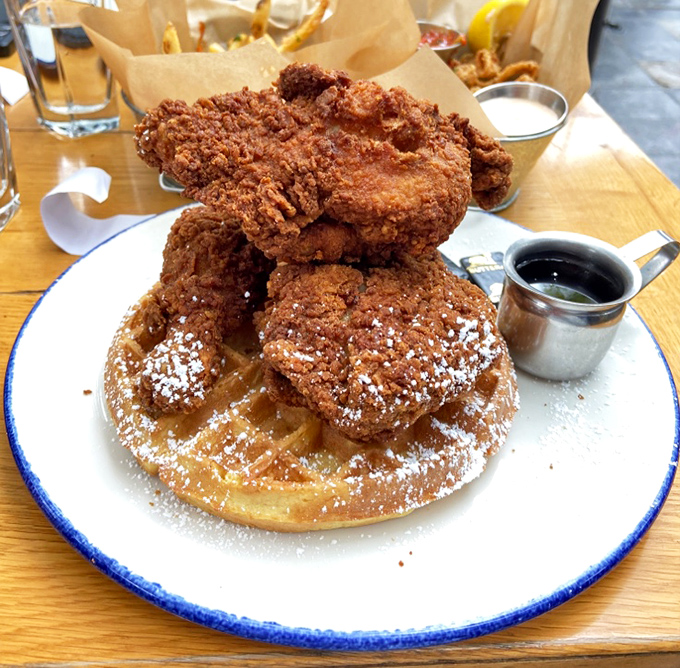 Behold the star attraction: golden-fried chicken atop a Belgian waffle dusted with powdered sugar. Your diet plan's worst nightmare, your soul's best friend.