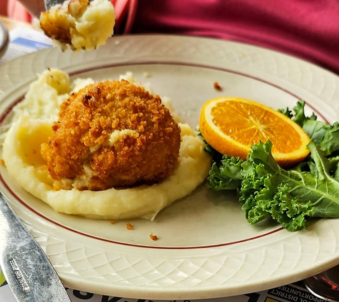 Behold the star attraction: a golden-brown chicken croquette perched atop cloud-like mashed potatoes. Poetry on a plate, Pennsylvania-style.