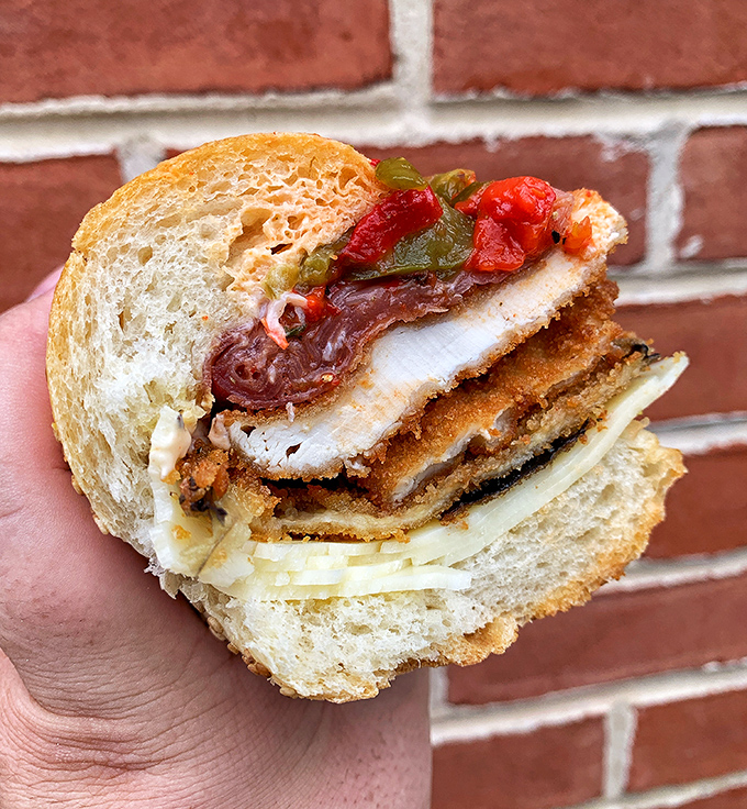 This chicken cutlet creation isn't just a sandwich; it's architecture with bread as the foundation and crispy, saucy goodness as the penthouse.