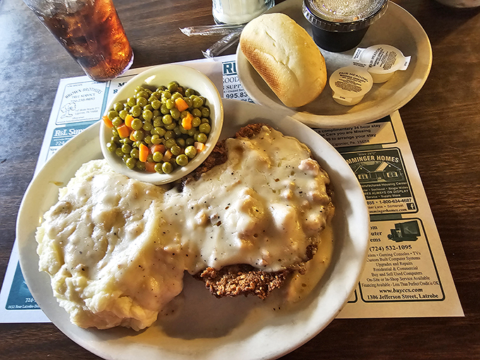Behold the star of our show! Chicken fried steak swimming in pepper-flecked gravy with mashed potatoes and peas. Comfort food that hugs your soul.