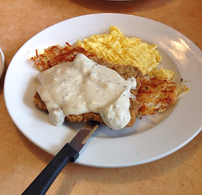 Behold the star attraction: chicken fried steak smothered in velvety country gravy, with golden hash browns and fluffy eggs.